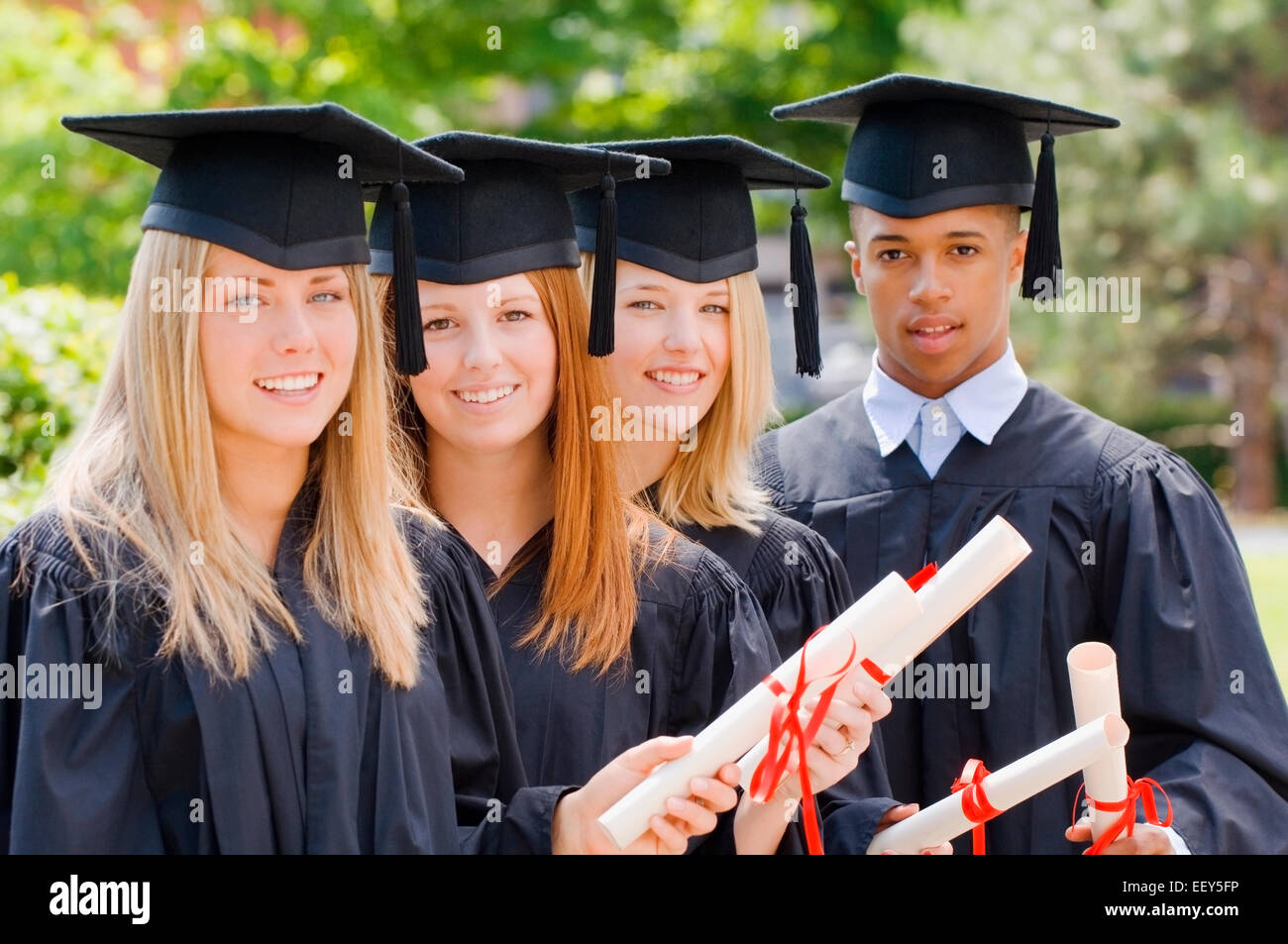 Four friends at graduation ceremony Stock Photo - Alamy