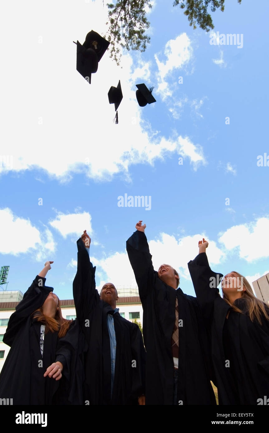 Four friends at graduation ceremony Stock Photo - Alamy