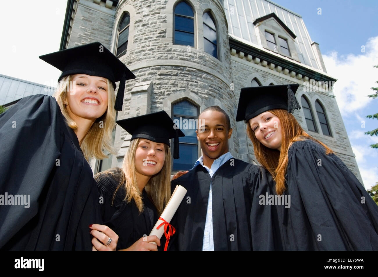 Four friends at graduation ceremony Stock Photo - Alamy