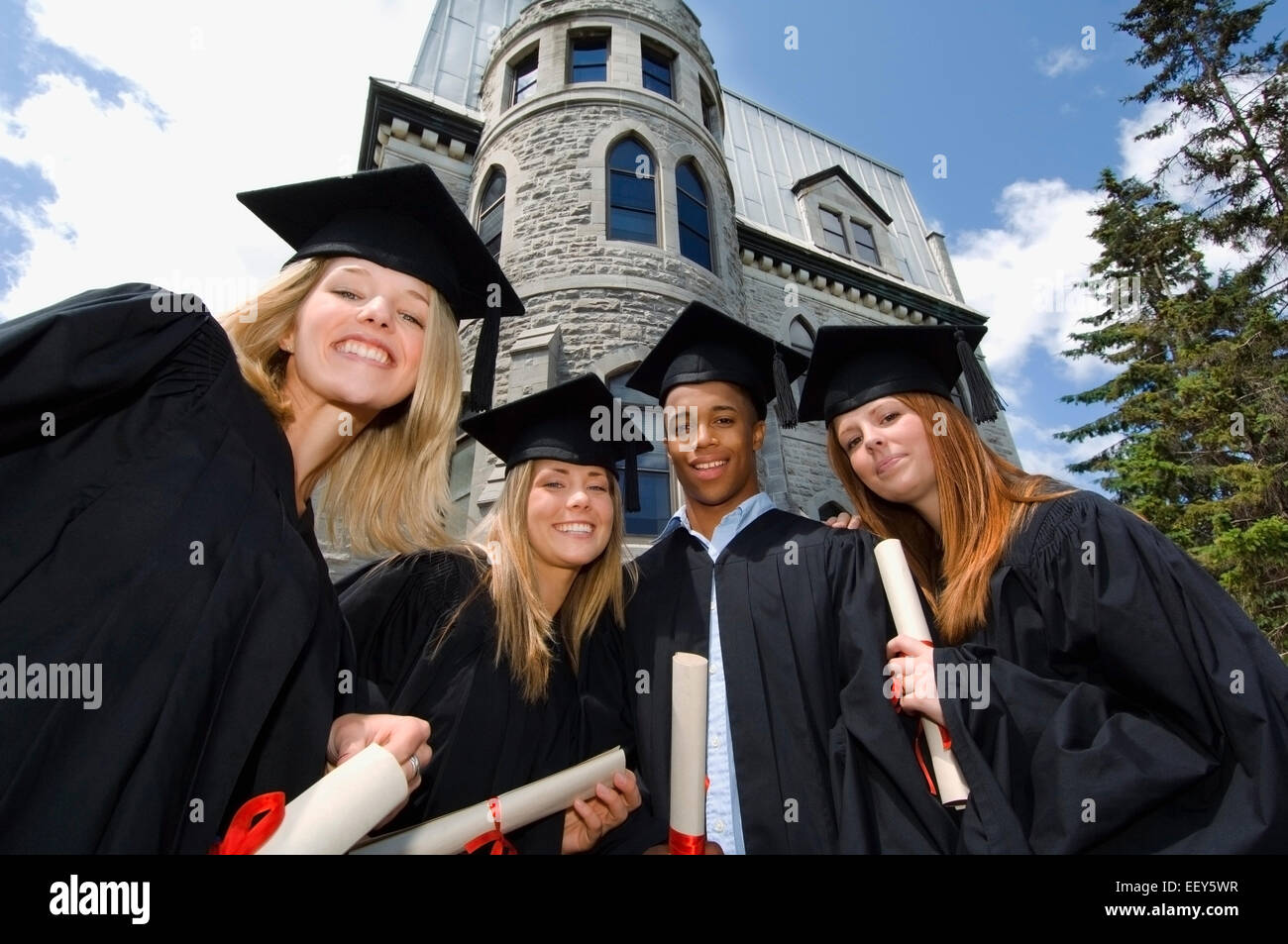 Four friends at graduation ceremony Stock Photo - Alamy