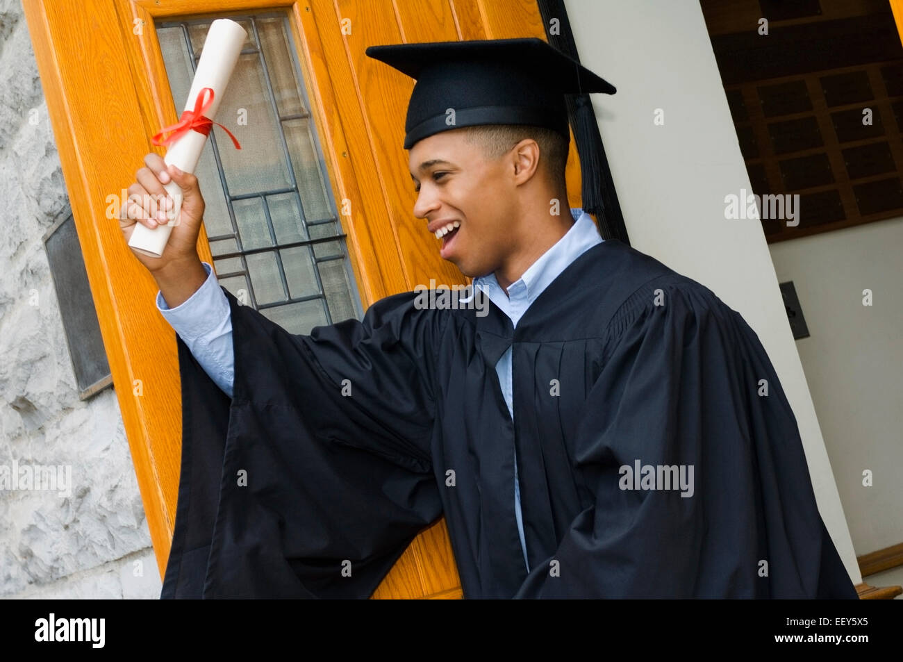 Young man with diploma on graduation day Stock Photo - Alamy