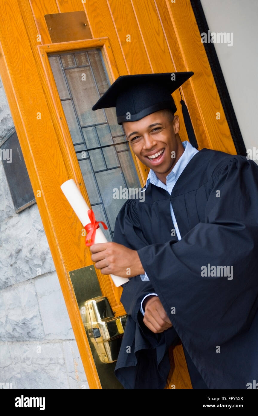 Young man with diploma on graduation day Stock Photo - Alamy