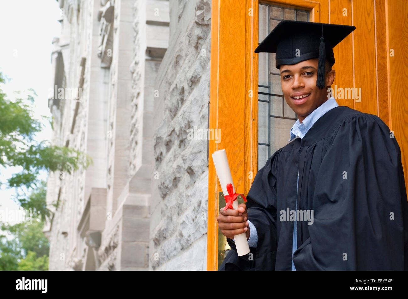 Young man with diploma on graduation day Stock Photo - Alamy