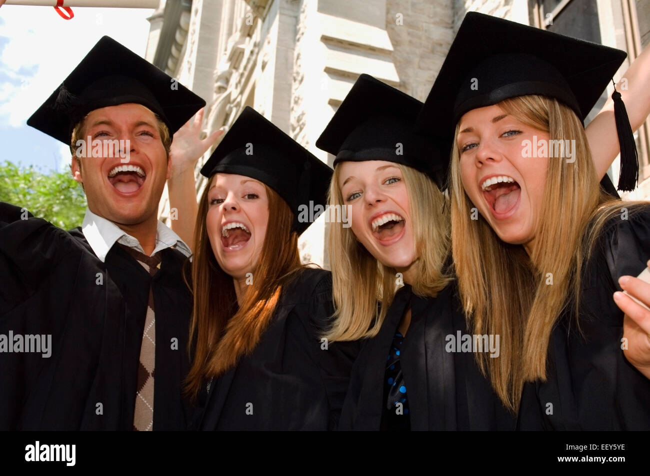 Four friends at graduation ceremony Stock Photo - Alamy