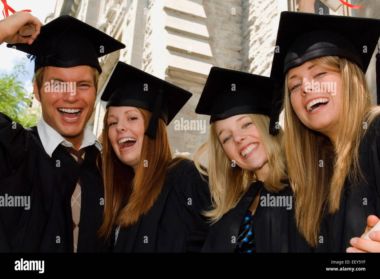 Four friends at graduation ceremony Stock Photo - Alamy