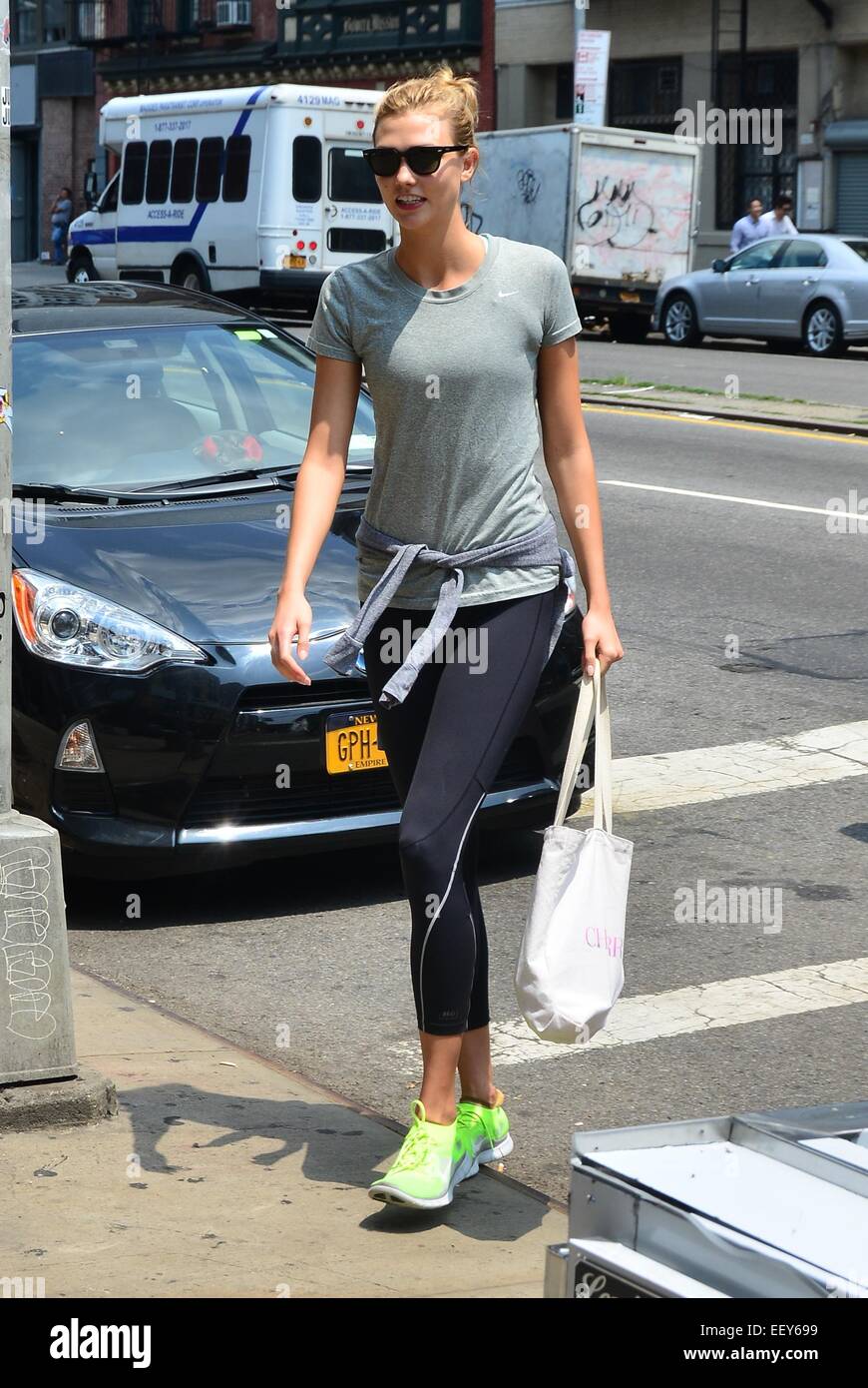 Taylor Swift showing a lot of skin in shorts and a white tank top while ...