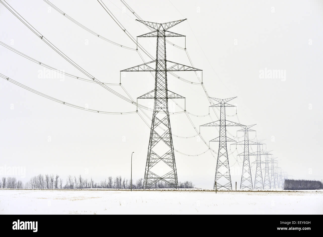 A horizontal landscape image of electricity transmission lines running ...