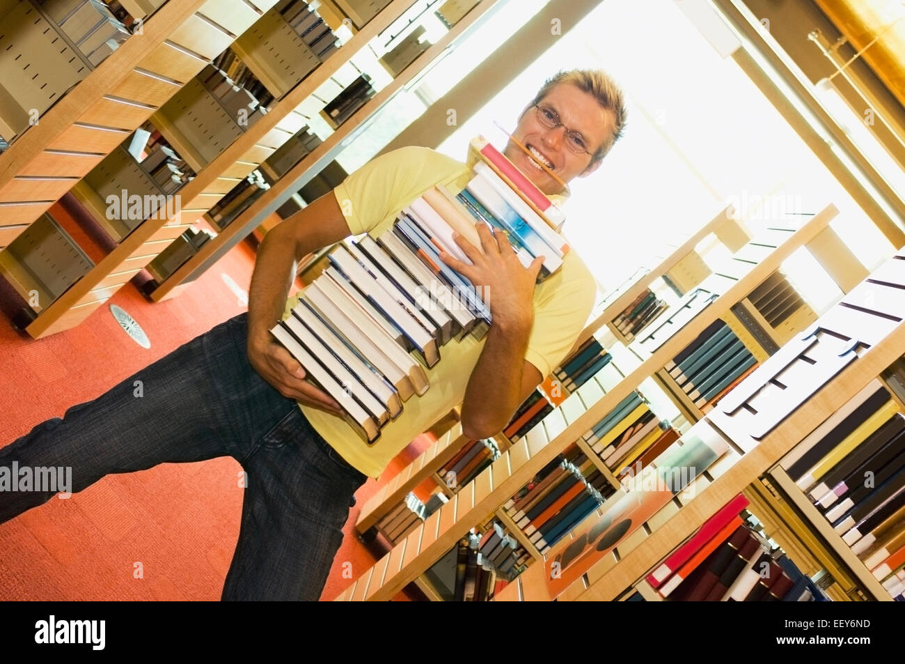 Young man in a library Stock Photo - Alamy