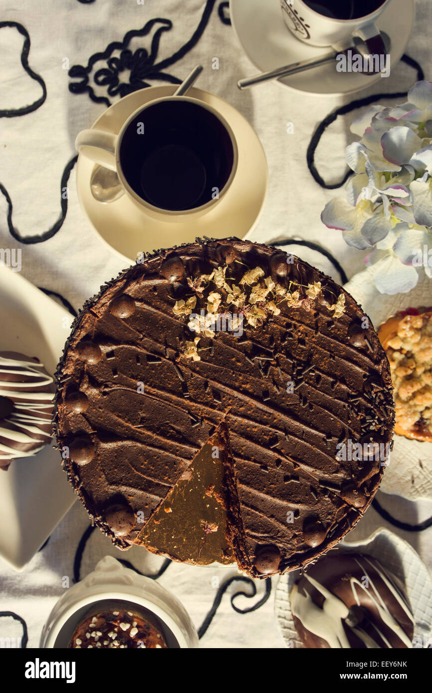 Chocolate cakes and Coffee table with teacups Stock Photo - Alamy