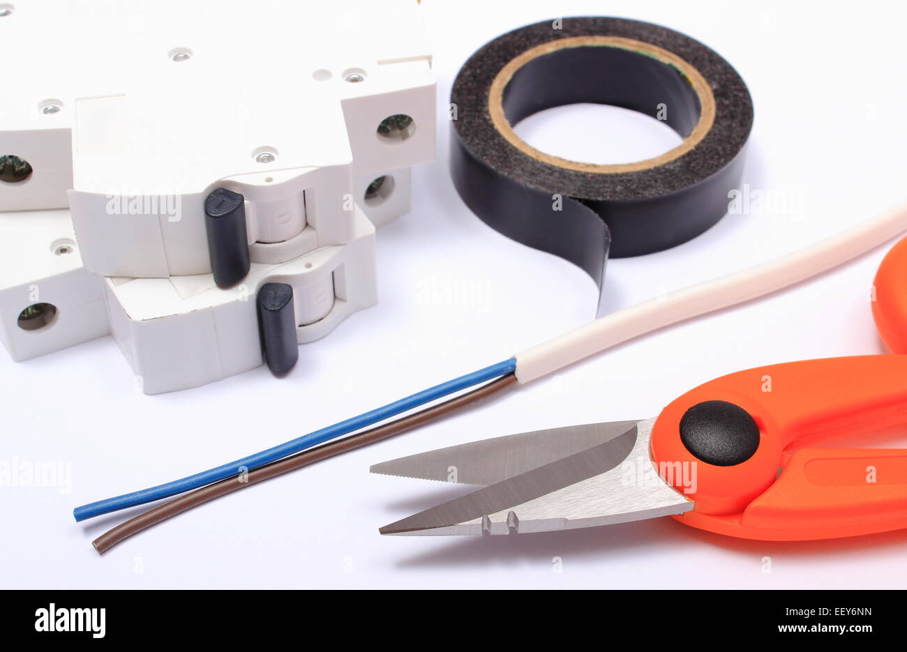 Cable cutter, electric wire and fuse, insulating tape lying on white ...