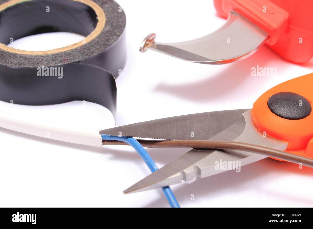 Cable cutter, electric wire and black insulating tape on white ...