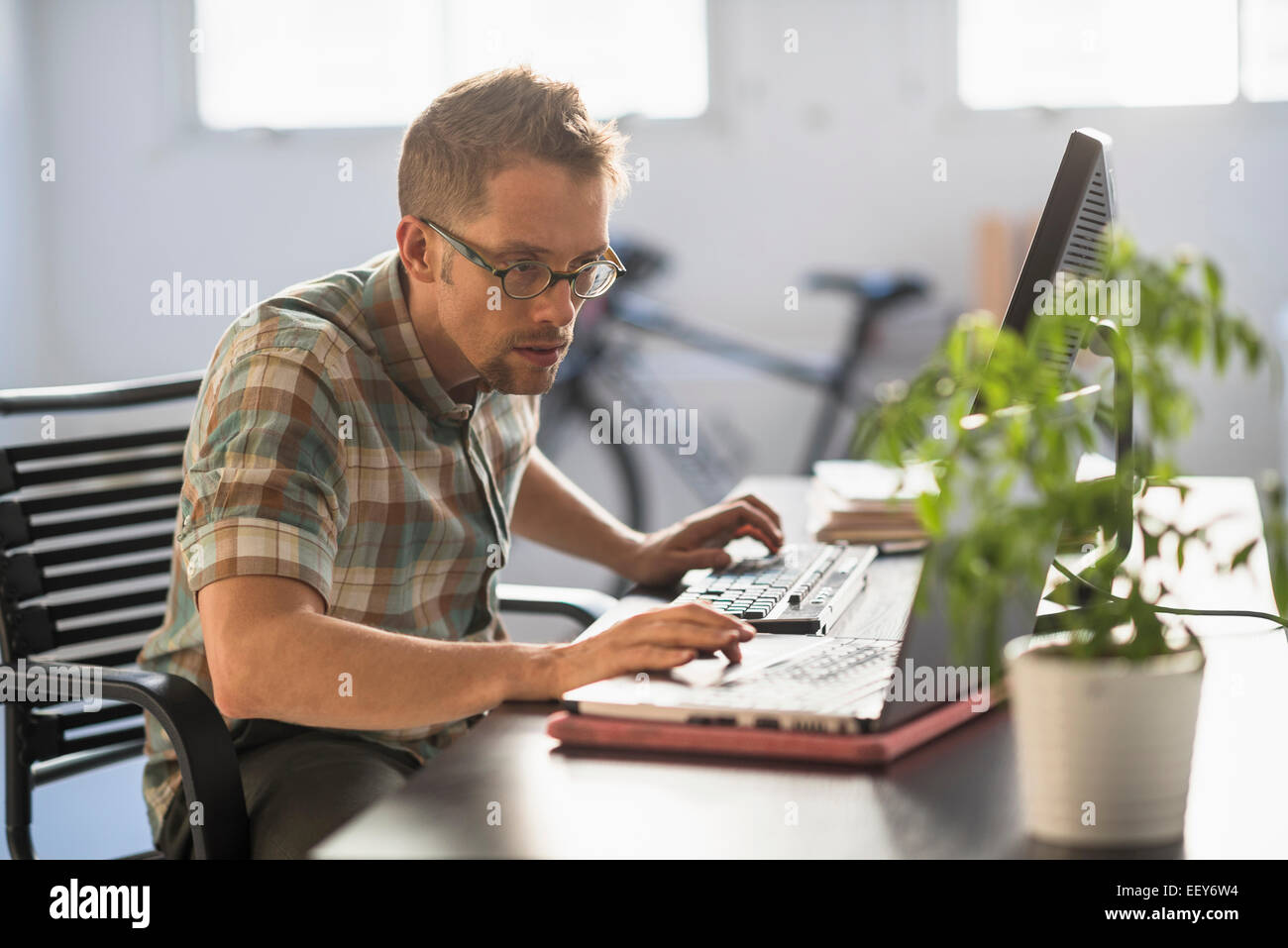 Man using computer in office Stock Photo - Alamy