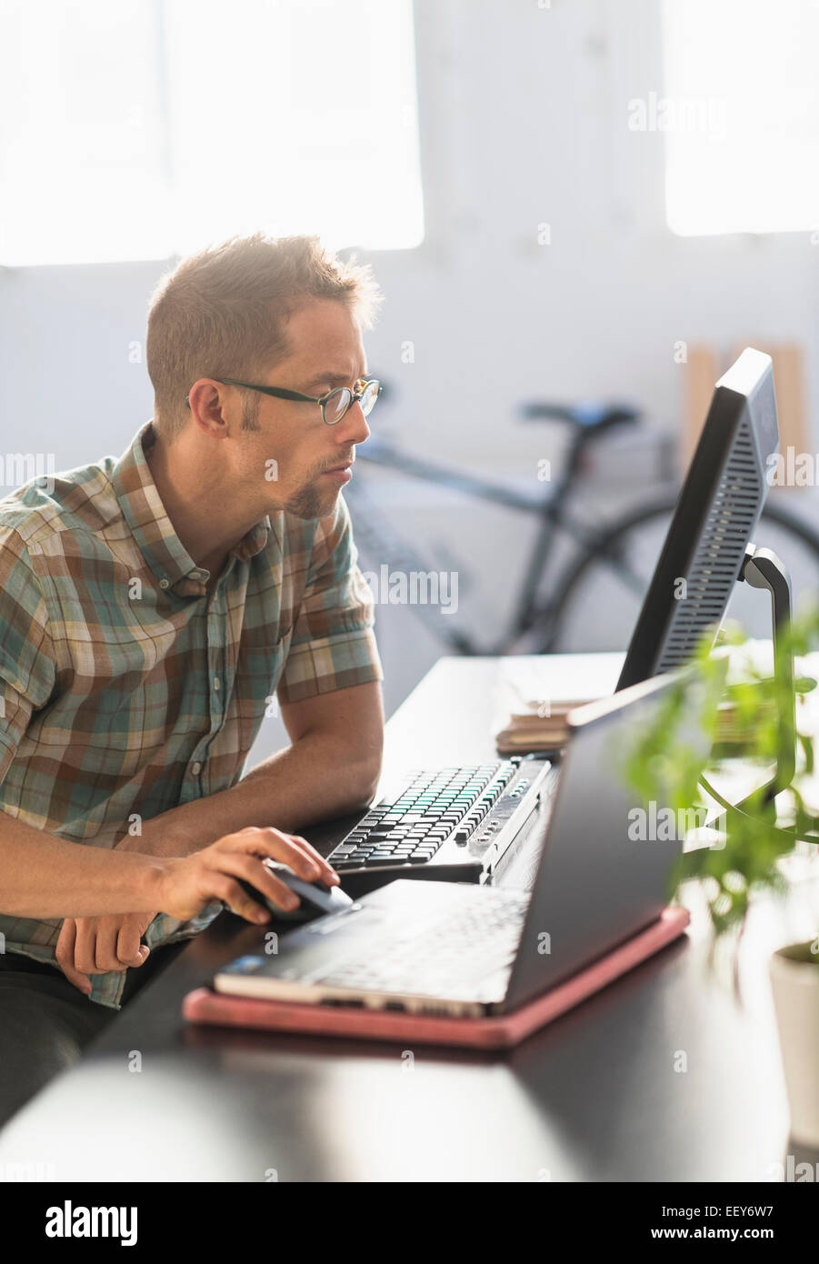 Man using computer in office Stock Photo - Alamy