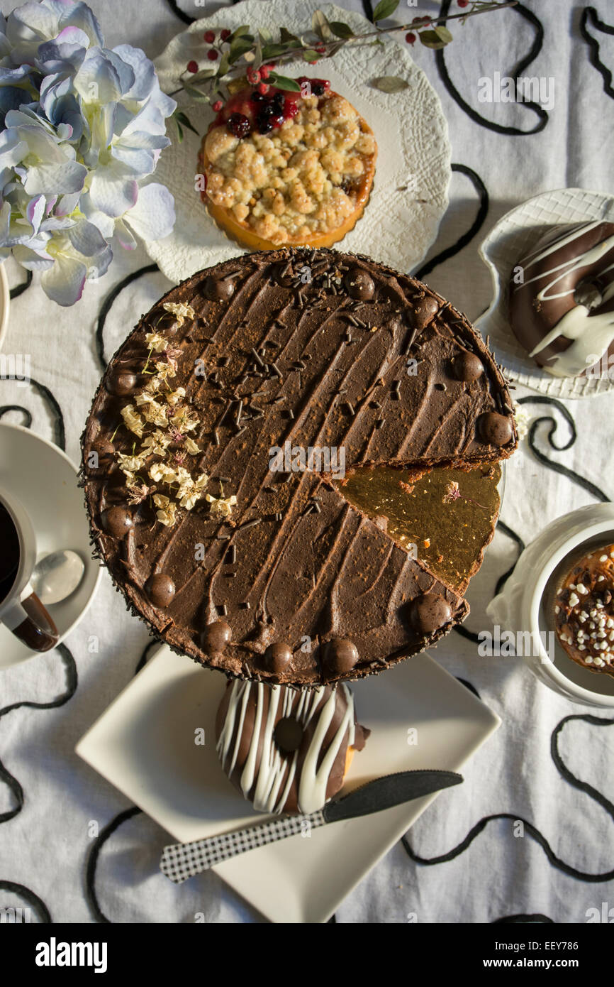 Chocolate cakes and Coffee table with teacups Stock Photo - Alamy