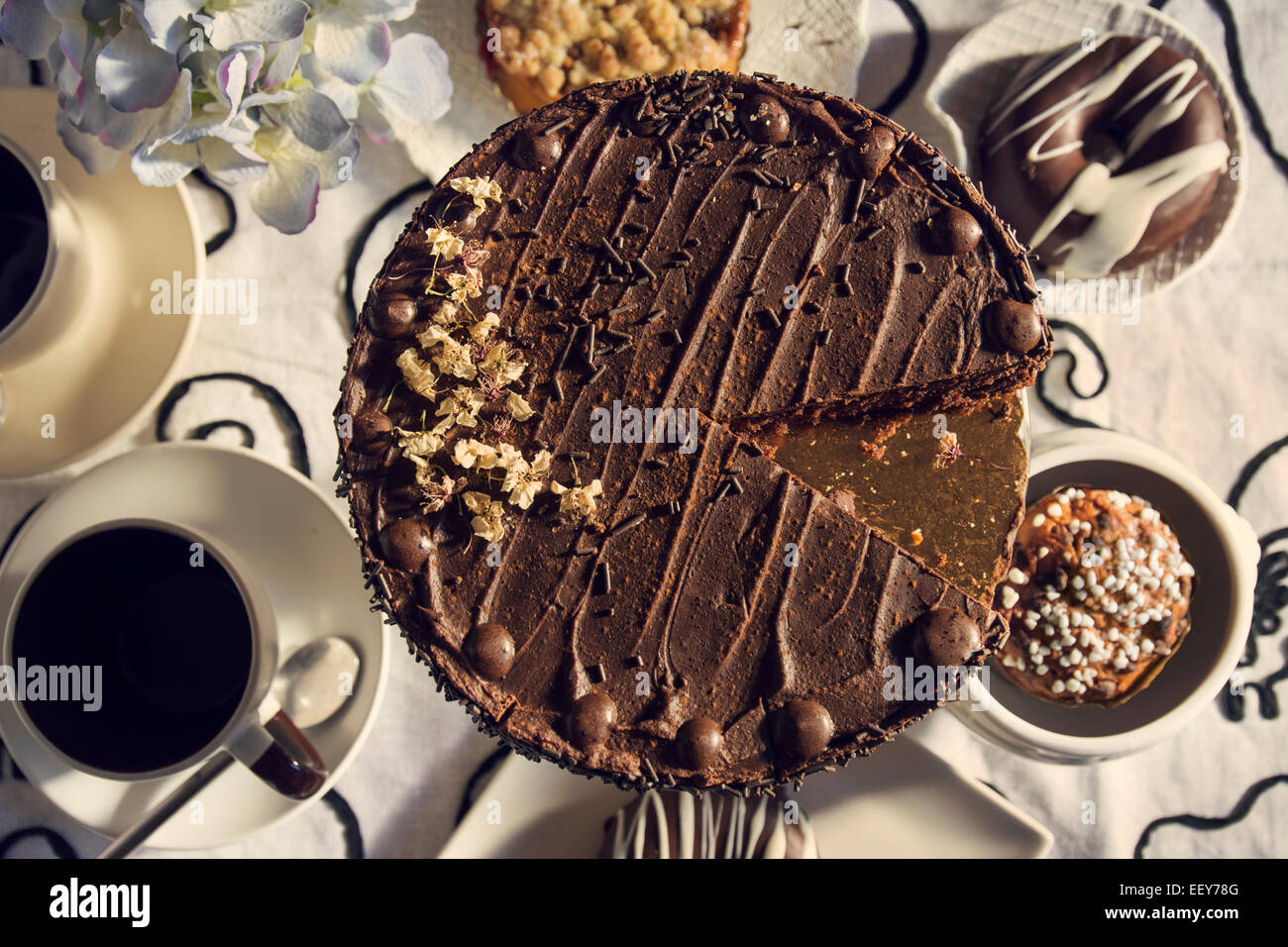 Chocolate cakes and Coffee table with teacups Stock Photo - Alamy