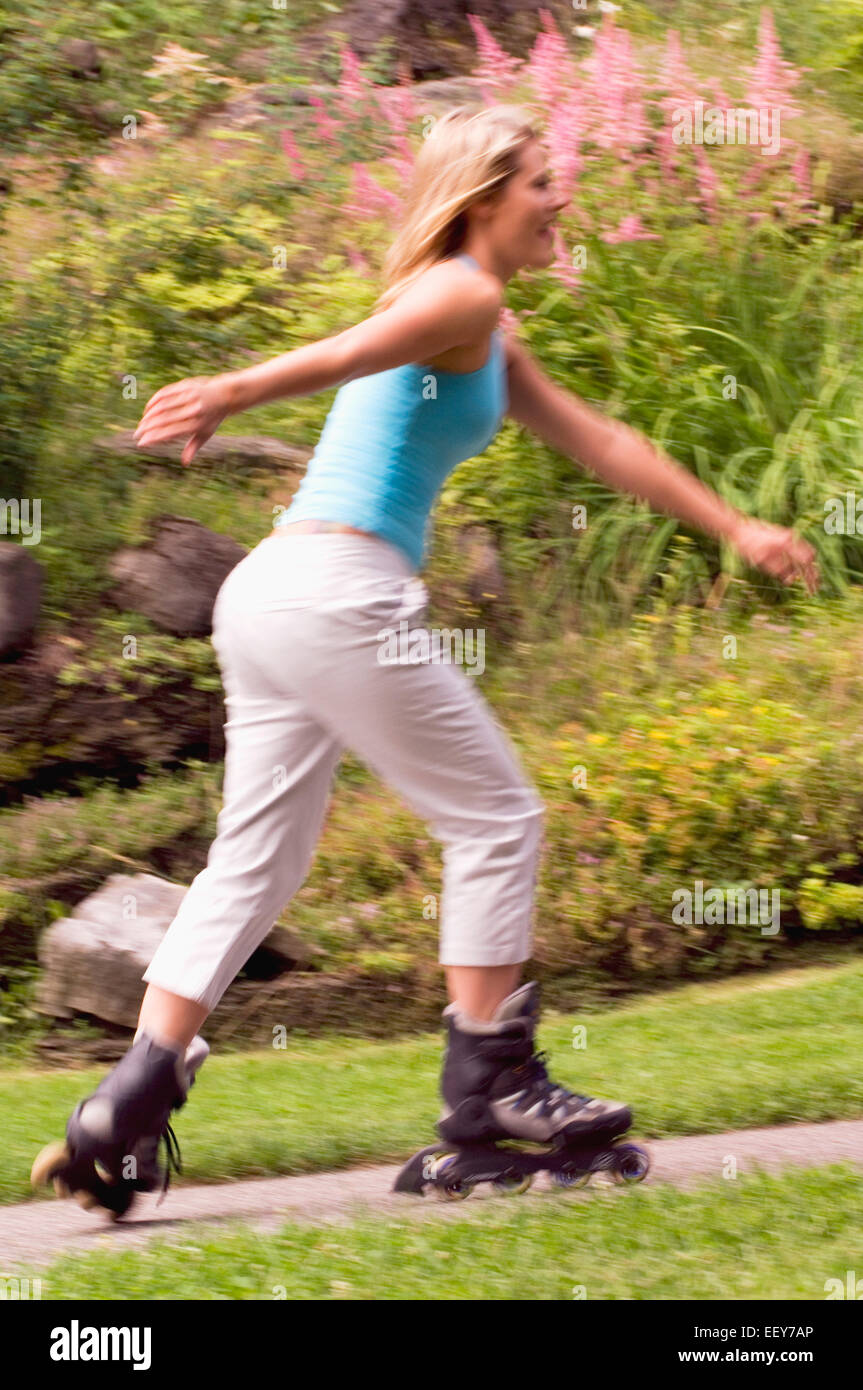 Woman inline skating at a park Stock Photo - Alamy