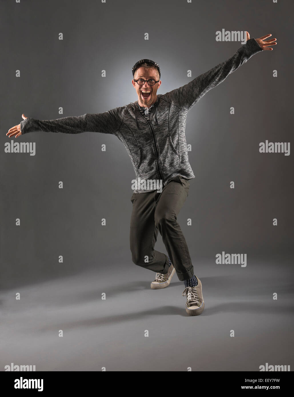 Studio shot of man in gray clothing Stock Photo - Alamy