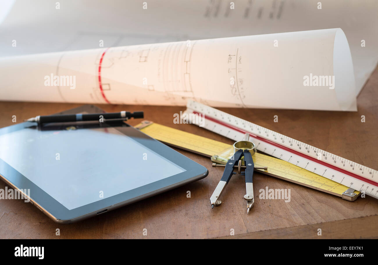 Close up of desk with plans, ruler, digital tablet and contractor Stock ...