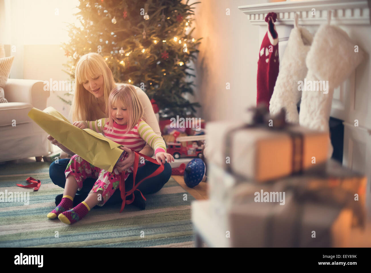 Family sitting around christmas tree hi-res stock photography and ...