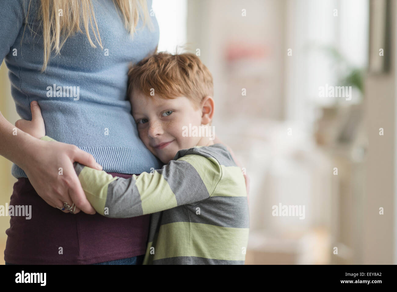 Boy hugging mother hi-res stock photography and images - Alamy