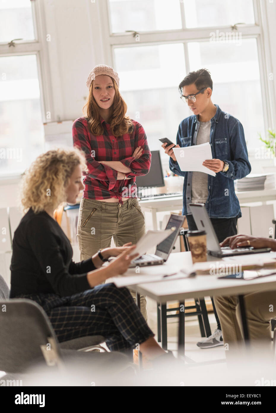 Friends working in office Stock Photo - Alamy