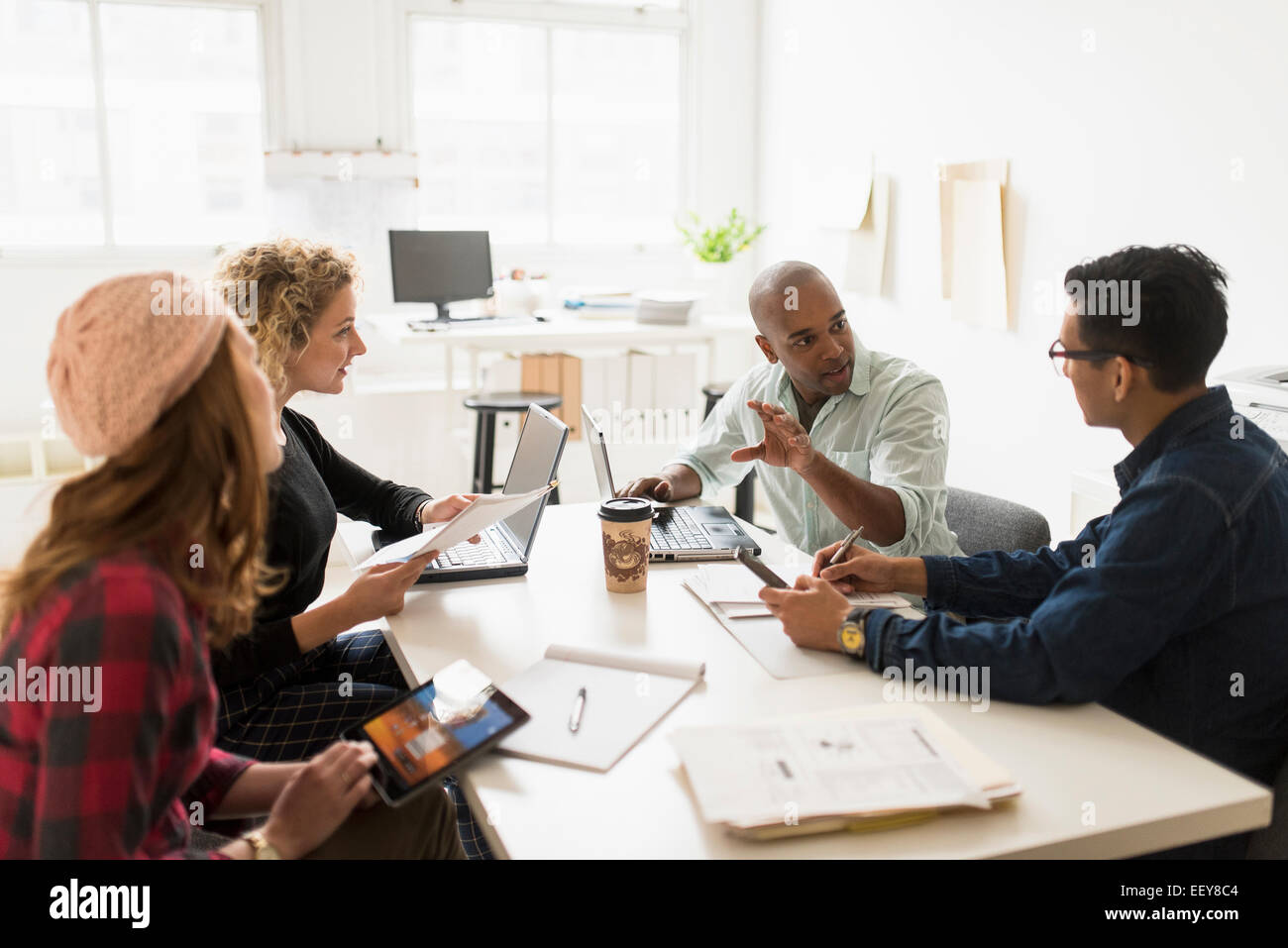 Friends having business meeting in office Stock Photo - Alamy