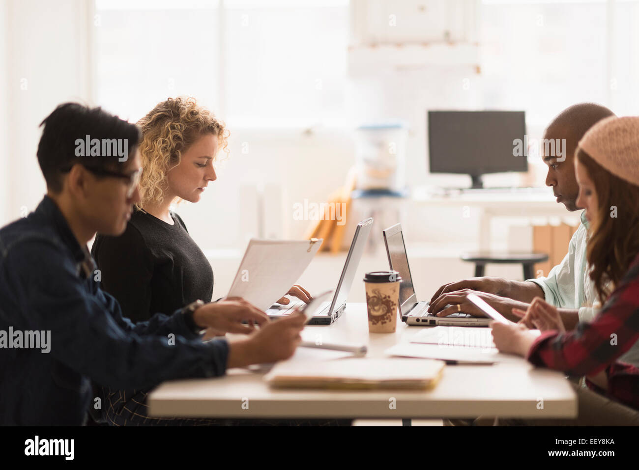 Friends having business meeting in office Stock Photo - Alamy