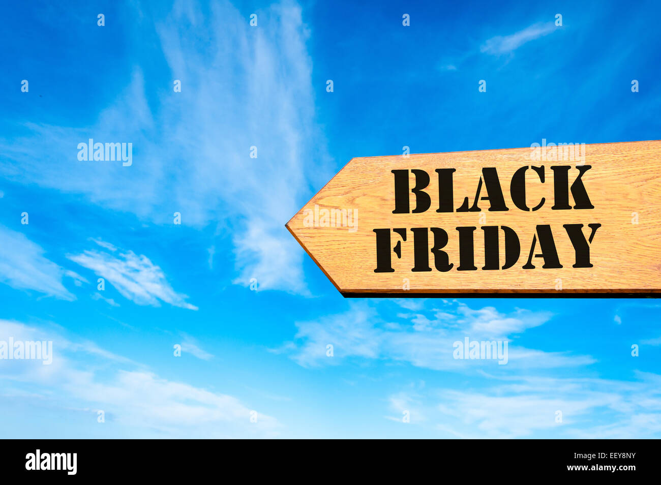 Wood arrow sign against clear blue sky with Black Friday message, Sales ...