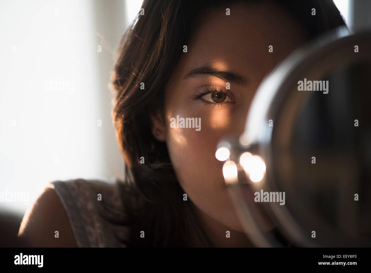 Young woman looking mirror hi-res stock photography and images - Alamy