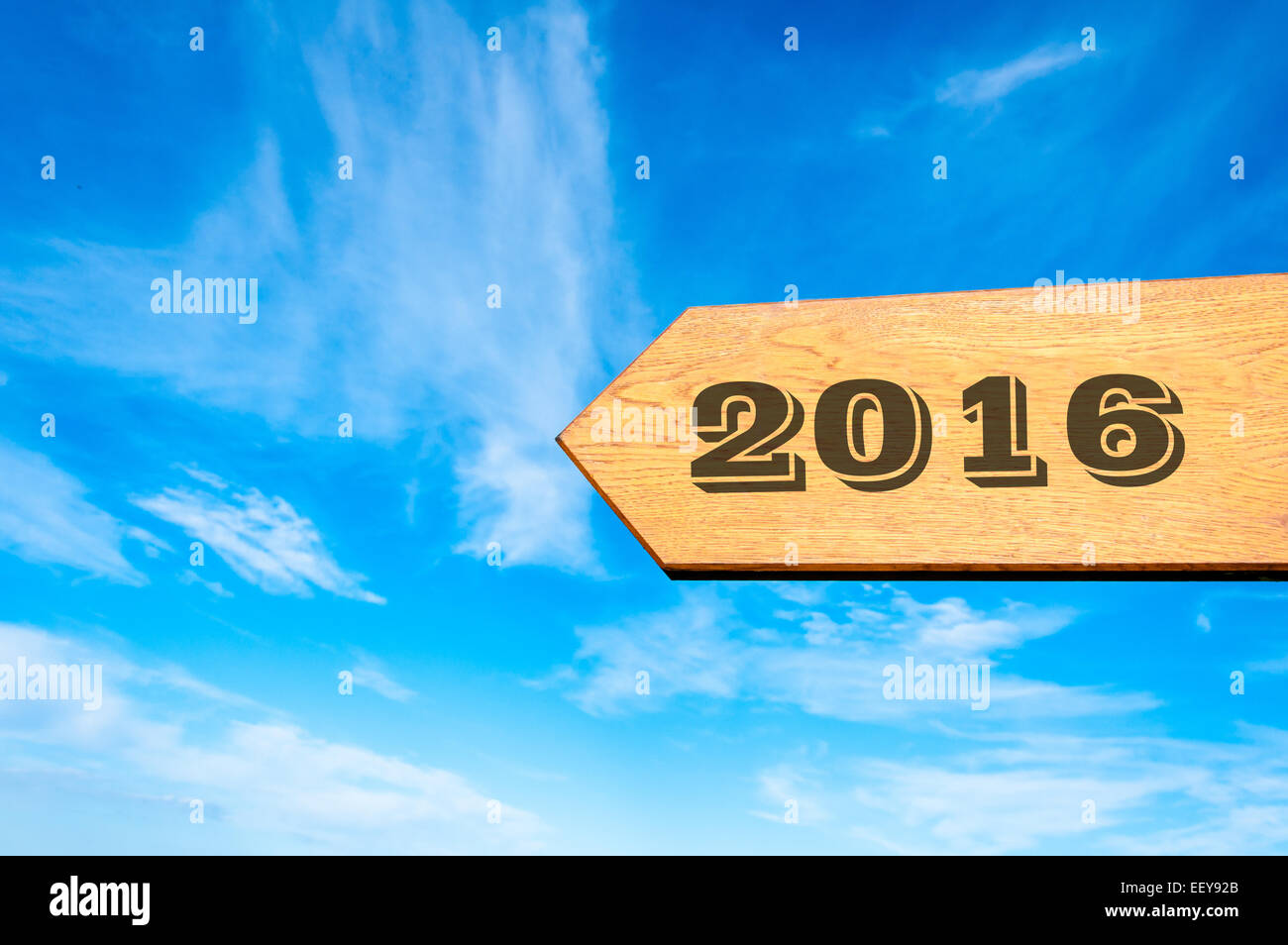 Wood arrow sign against clear blue sky with year 2016 text, Happy New ...