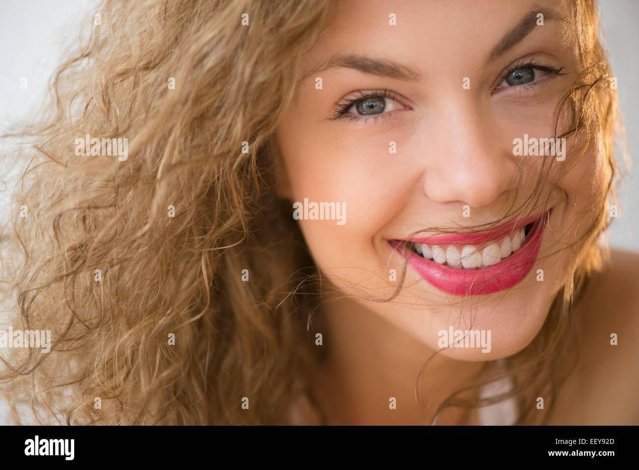 Cheerful blonde woman curly hi-res stock photography and images - Alamy