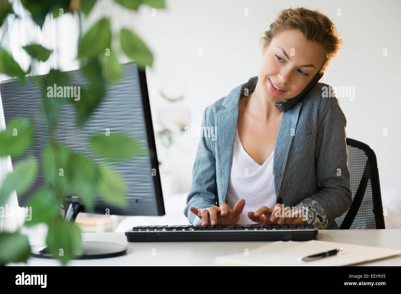 Young businesswoman working on desktop computer in office Stock Photo ...