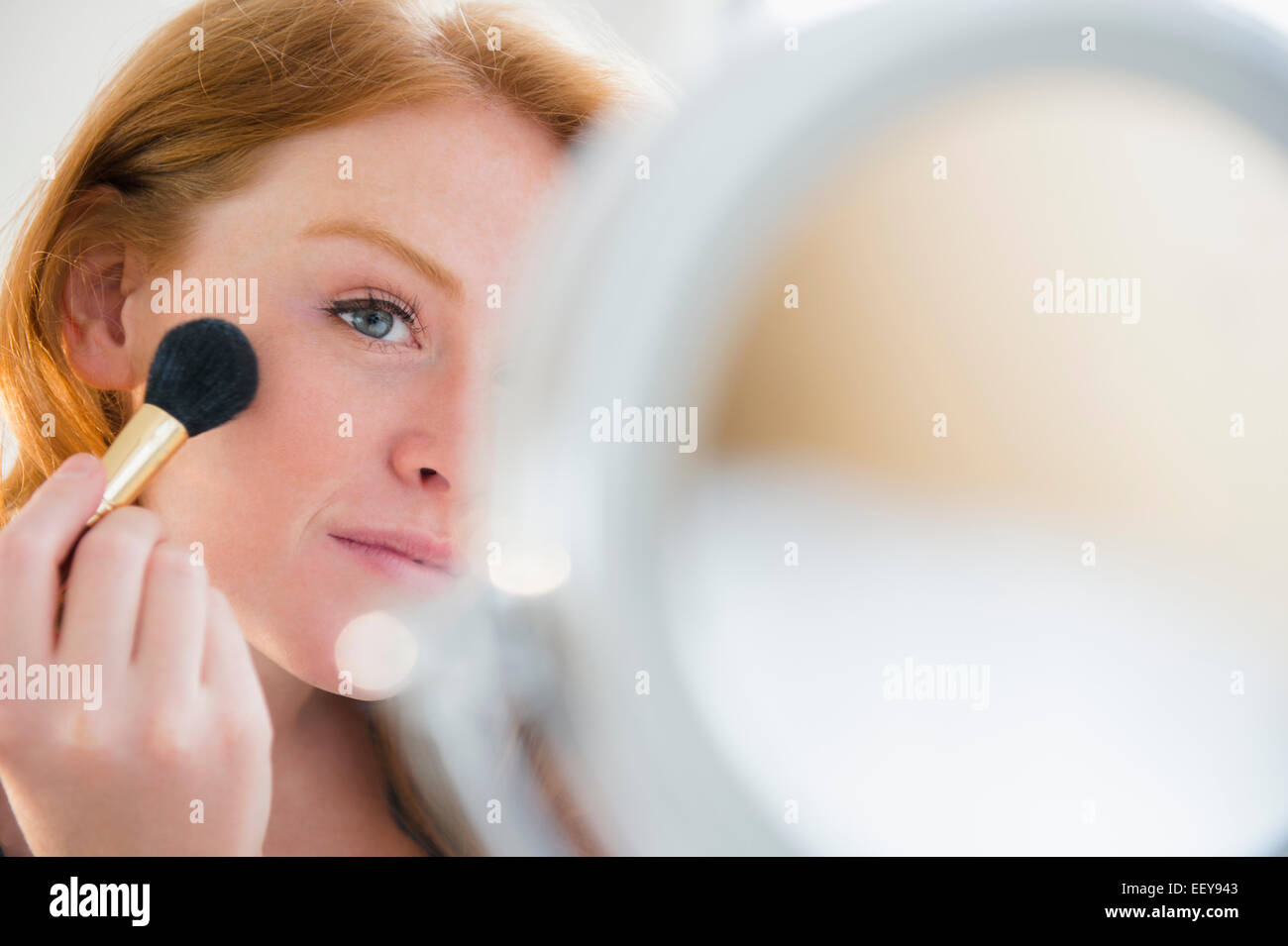 Young woman applying make up Stock Photo - Alamy