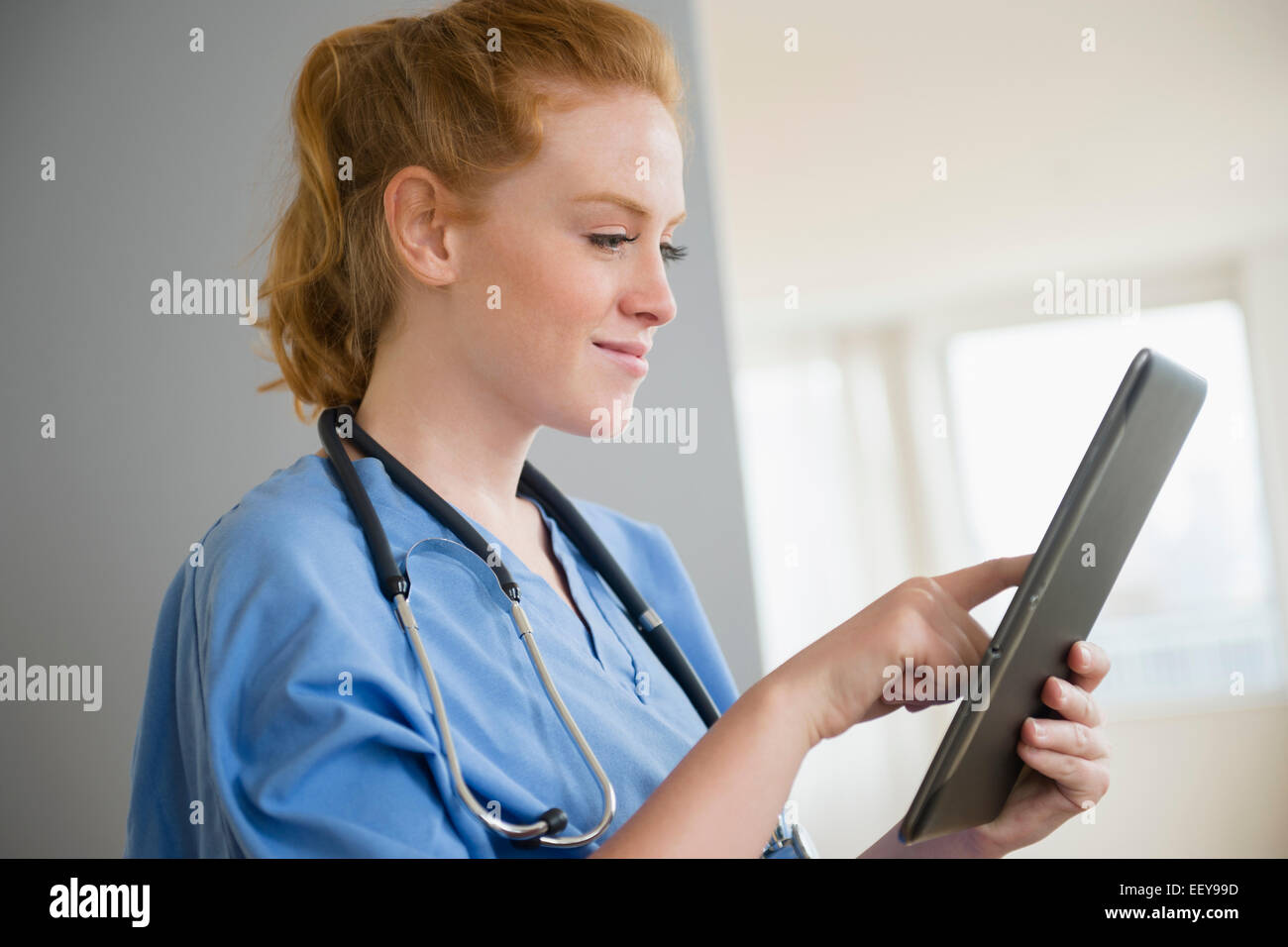 Female nurse using digital tablet Stock Photo - Alamy