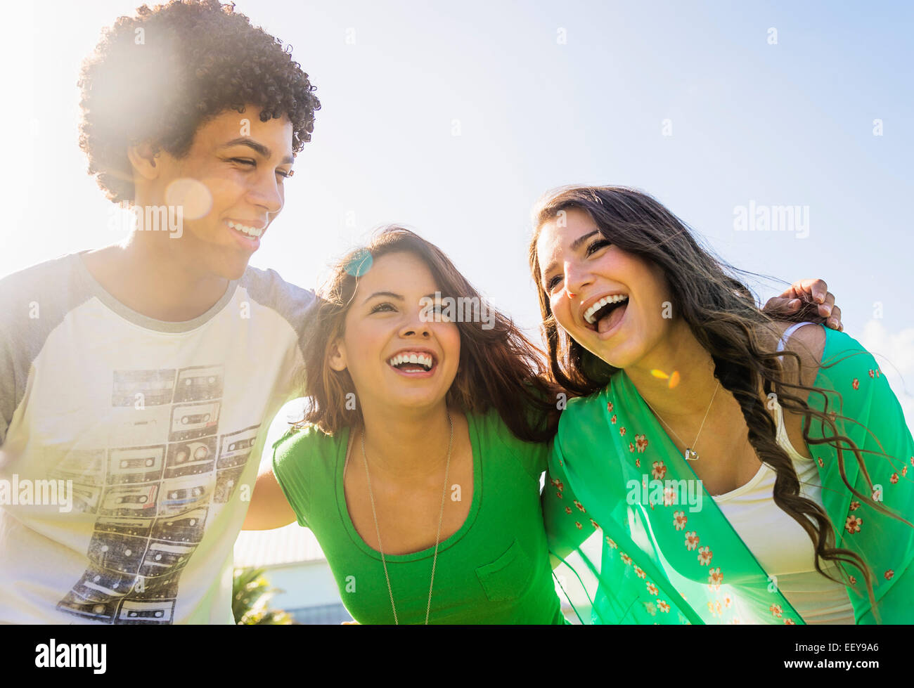 Group of friends (14-15) embracing and laughing Stock Photo - Alamy