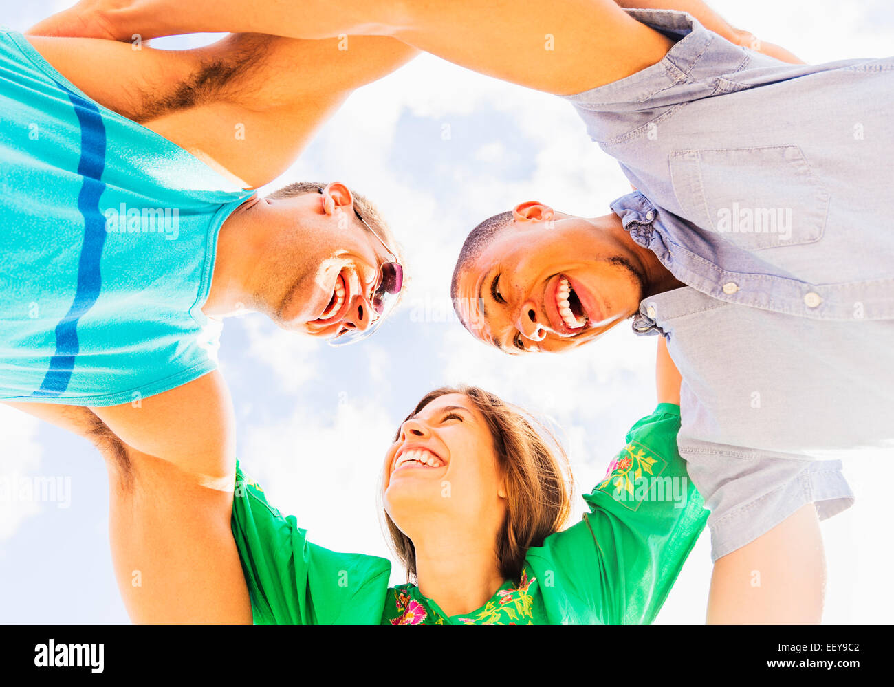 Young people with arms around each other Stock Photo - Alamy