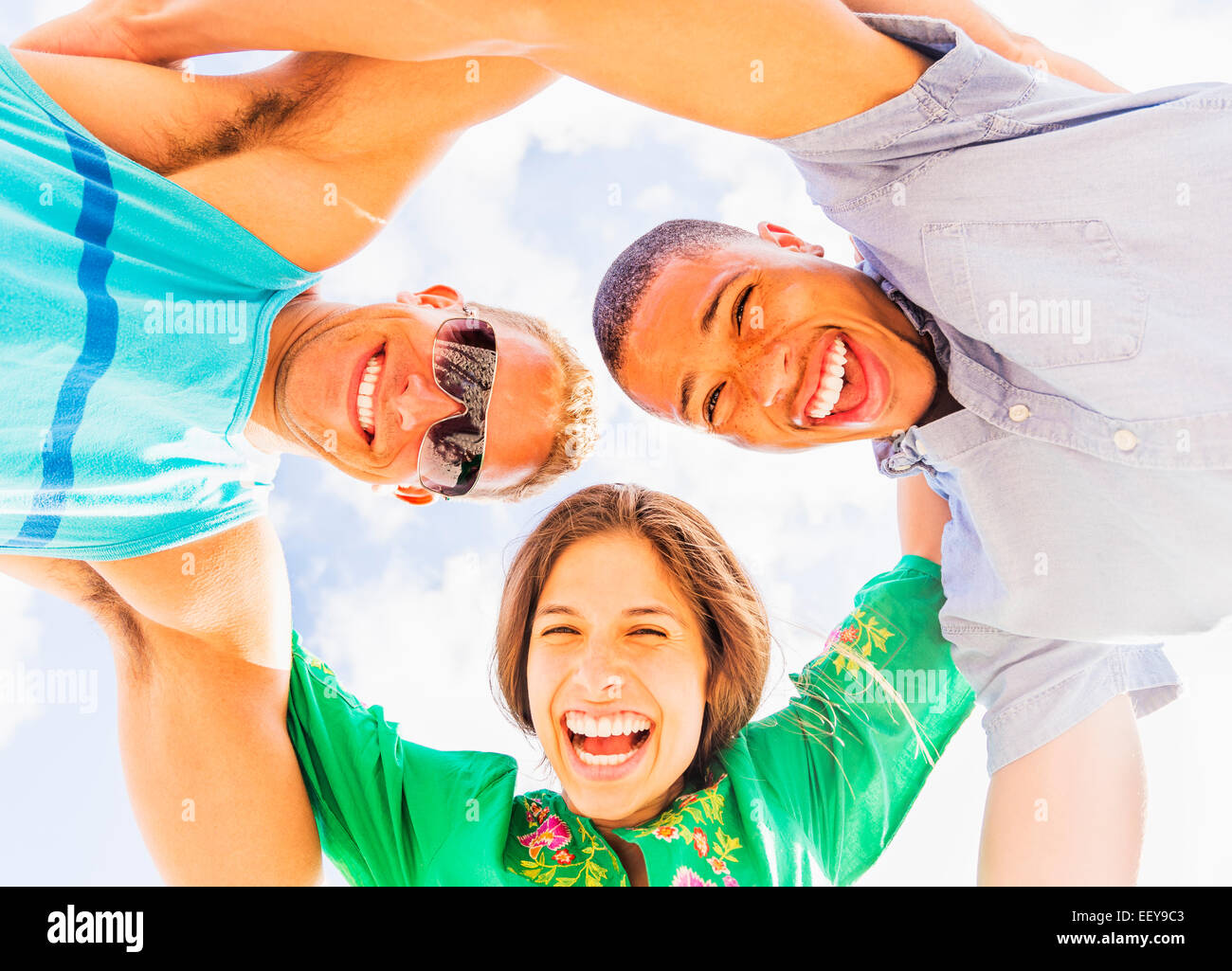 Portrait of young people with arms around each other Stock Photo - Alamy