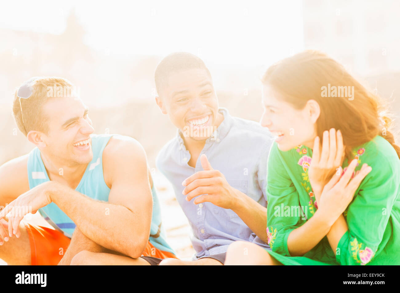 Young people talking and laughing outdoors Stock Photo - Alamy