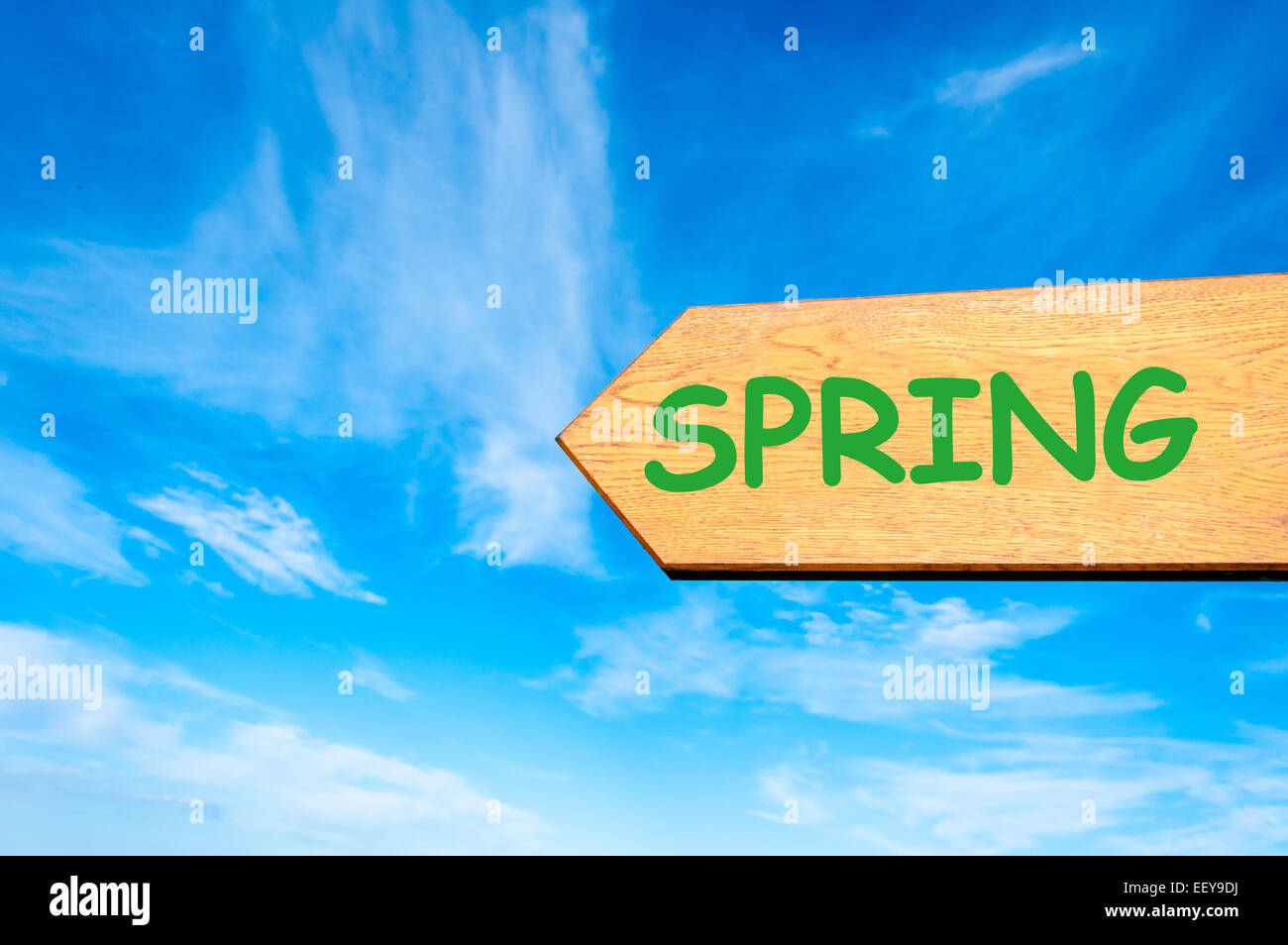 Wood arrow sign against clear blue sky with Spring message, Season ...