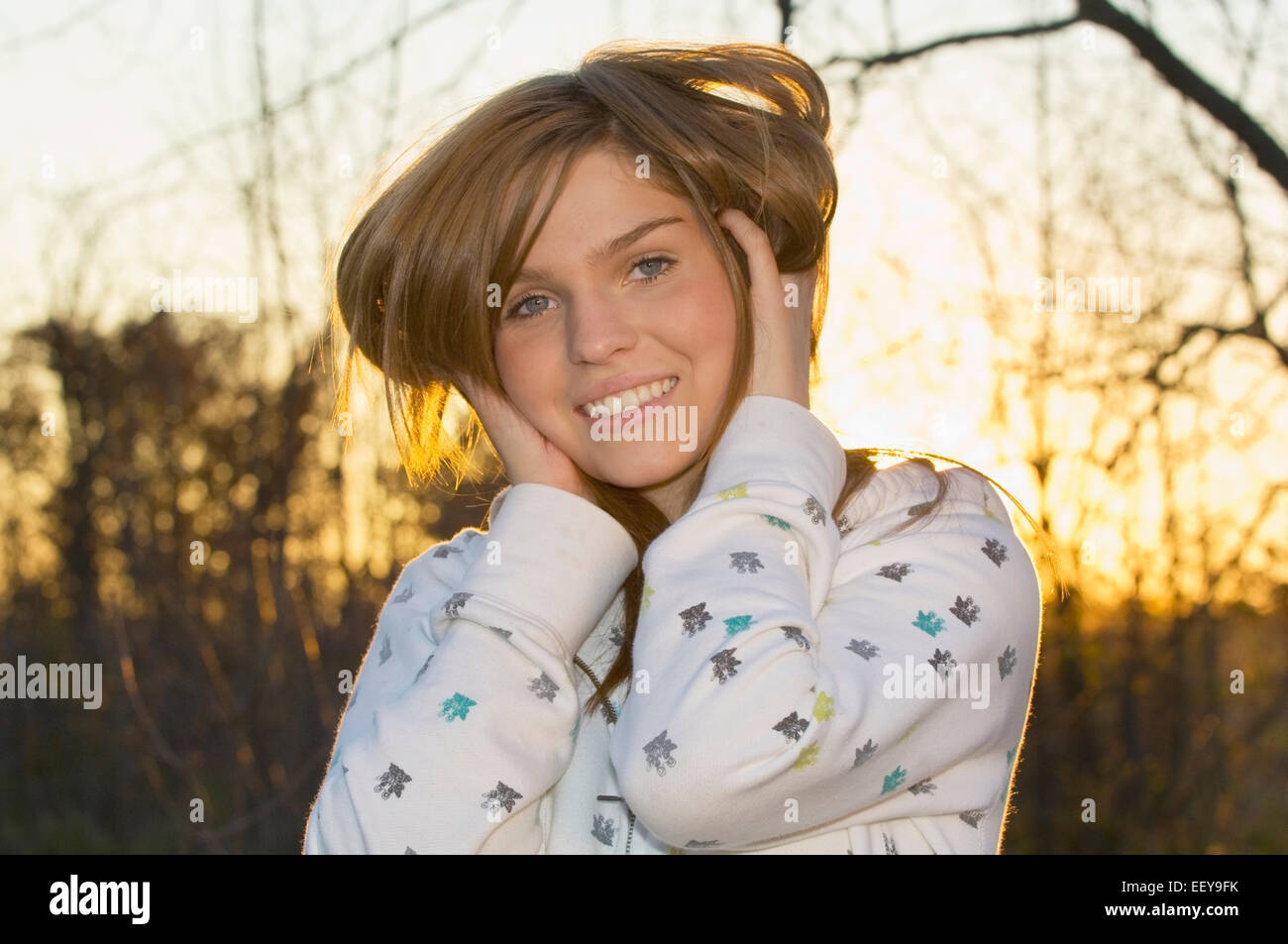 Young woman outdoors at dusk Stock Photo - Alamy