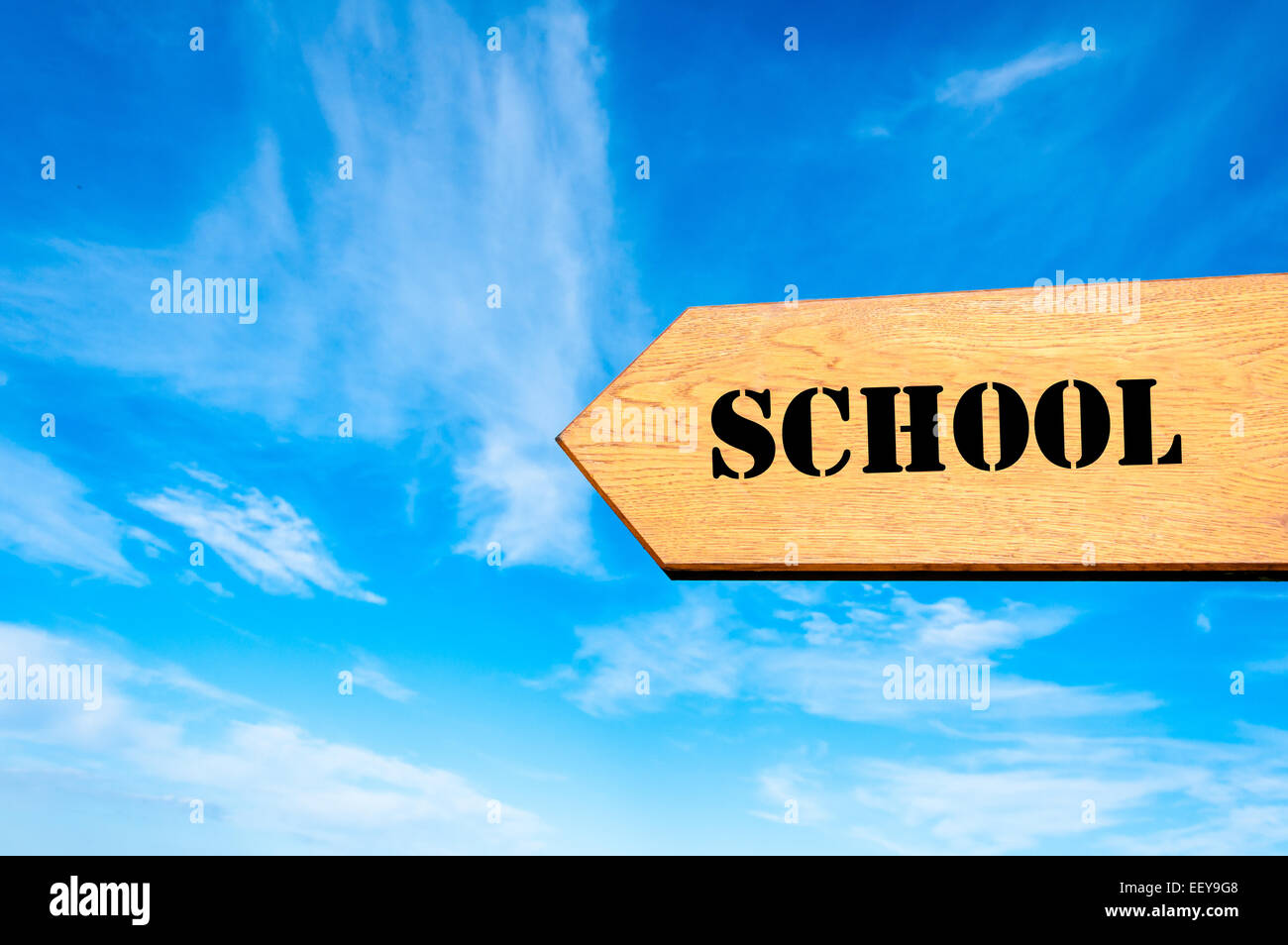 Wood arrow sign against clear blue sky with School message Stock Photo ...
