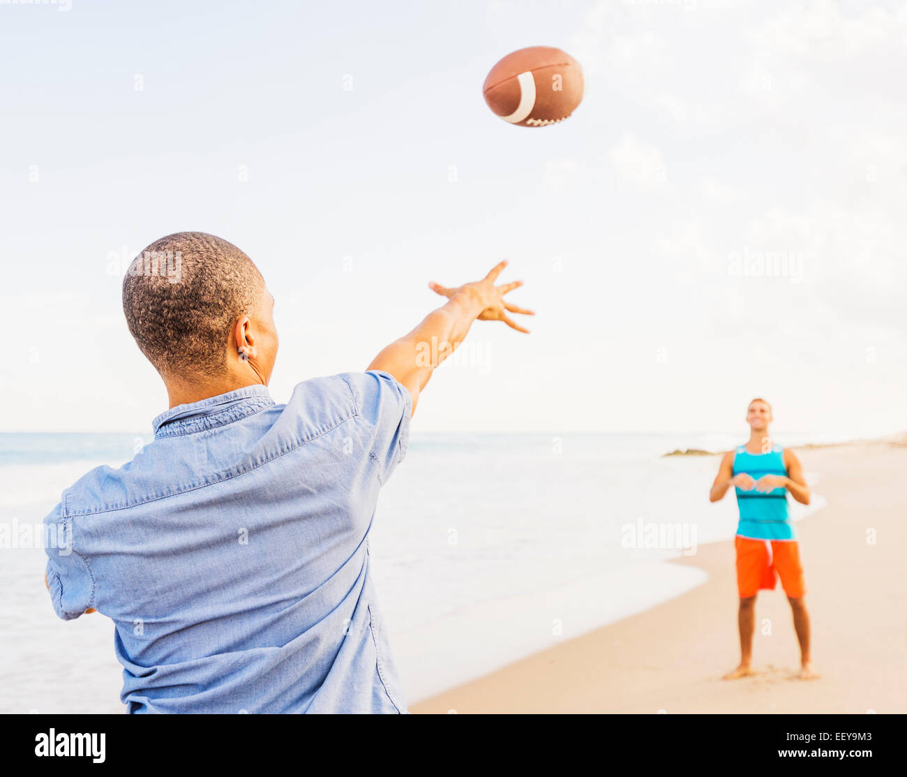 USA, Florida, Jupiter, Young men playing football on beach Stock Photo ...