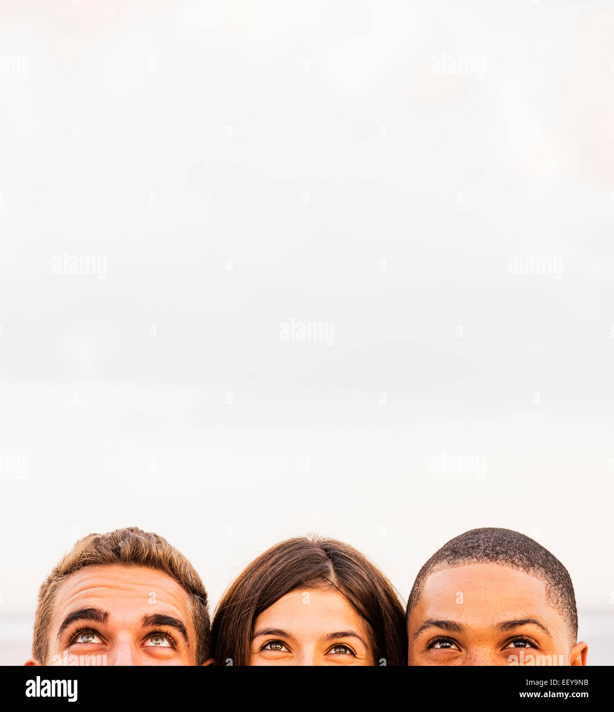 High section of young people looking up Stock Photo - Alamy