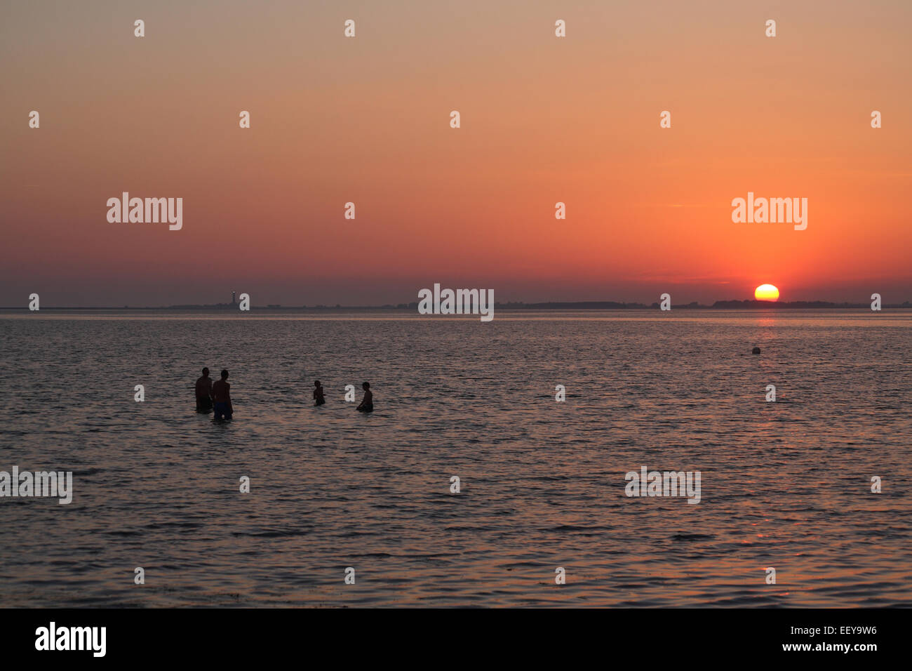 Strukkamp, Germany, tourists take a bath at sunset Stock Photo - Alamy