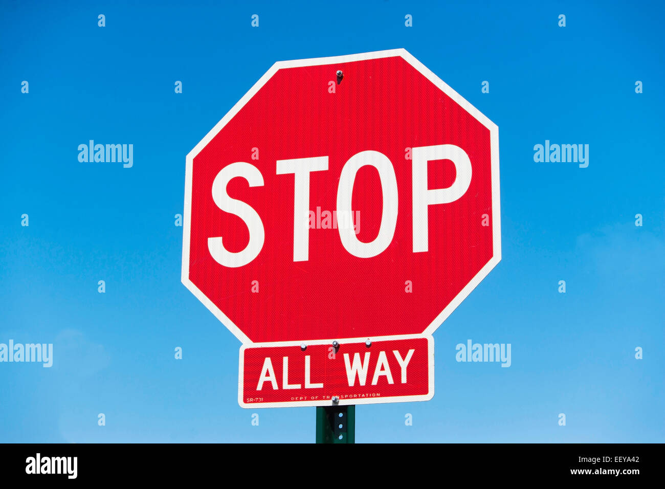 Stop sign on clear sky Stock Photo - Alamy