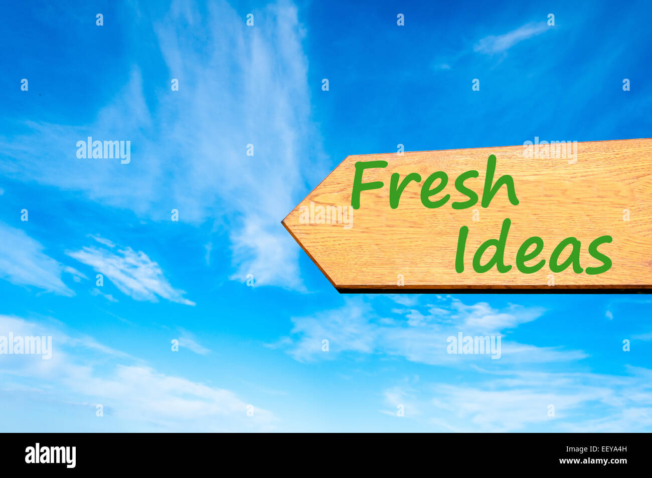 Wood arrow sign against clear blue sky with Fresh Ideas message Stock ...