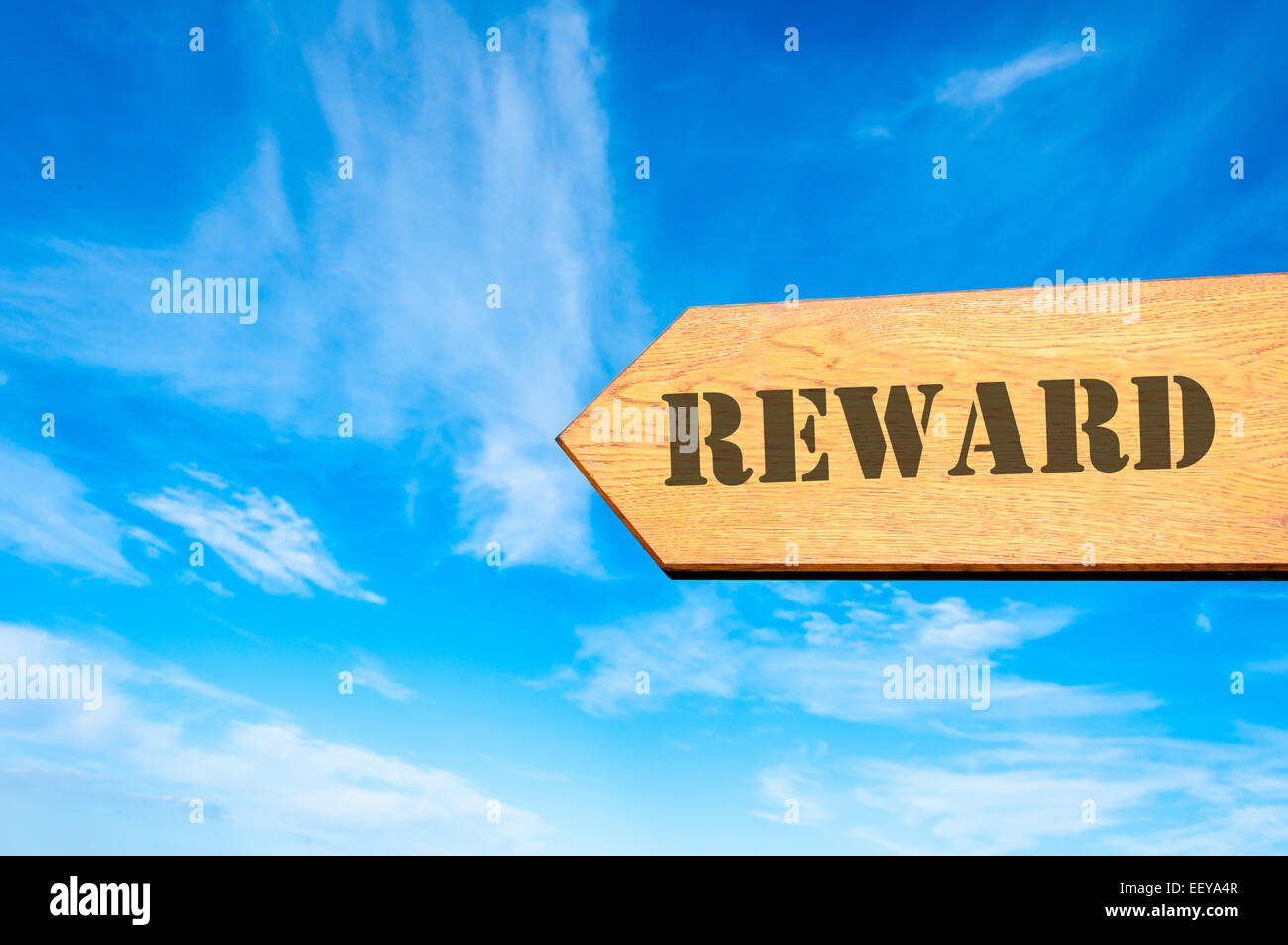 Wood arrow sign against clear blue sky with Reward message Stock Photo ...