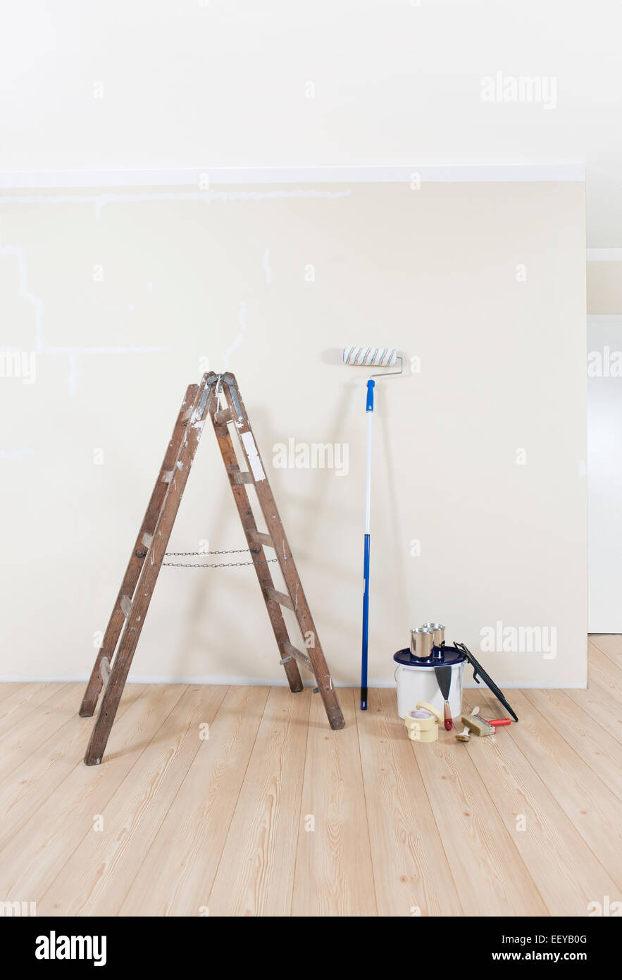 Painting supplies with ladder against a wall to be repainted Stock ...