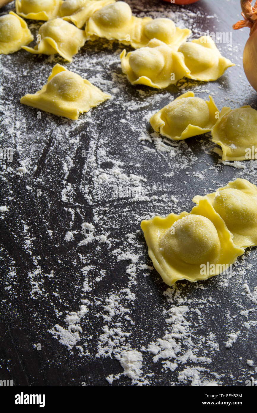 Raw ravioli on black background Stock Photo - Alamy