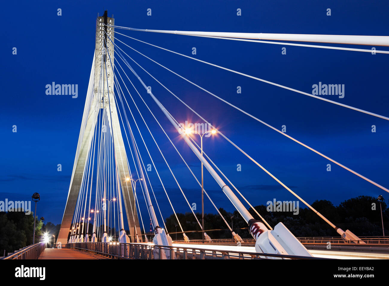 Poland, Mazowieckie, Warsaw, Tower and cables of illuminated ...